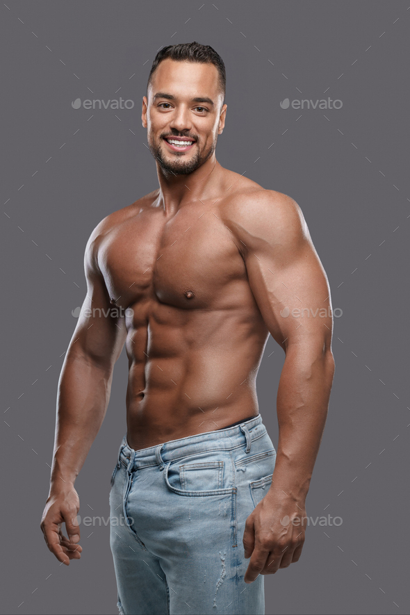 Charming and muscular male model with a dazzling smile Stock Photo by ...