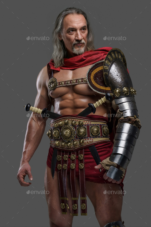 Aged but still mighty muscular gladiator with long grey hair and beard ...