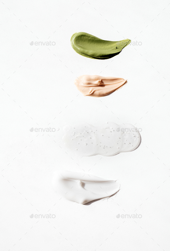 Cosmetic smears of green, pink and white colors cream on bright ...