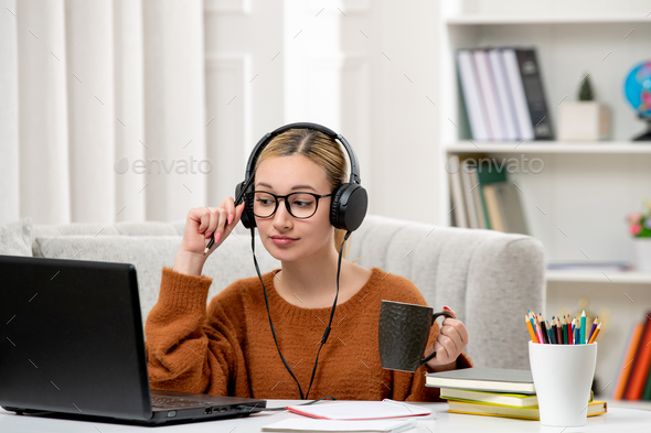 student online cute girl in glasses and sweater studying on computer ...
