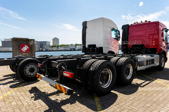 Back view many new heavy commercial cargo transport vehicles stand at ...