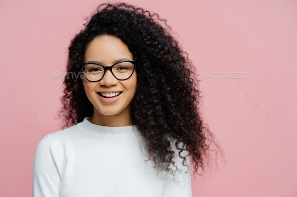 Charming young female, Afro hairstyle, pleasant smile, very happy ...