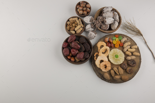 Dry fruits and snacks in multiple wooden platters and saucers Stock ...