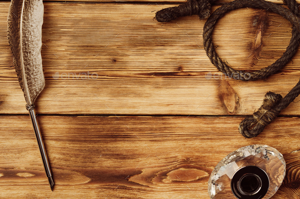 Feather pen and inkwell on wooden background top view Stock Photo by ...