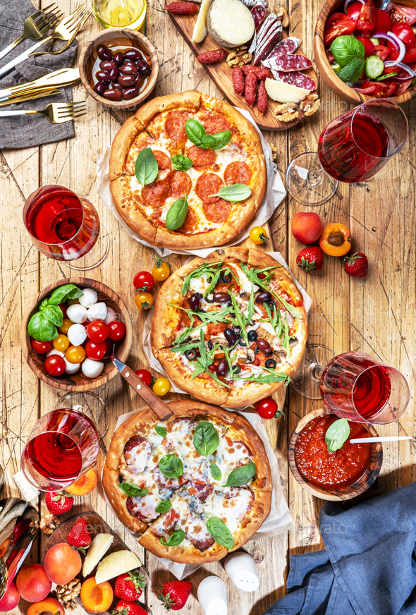 Pizza party table. Top view glasses with red wine, rustic wooden table ...