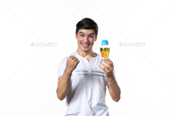 front view young man with bottle of lemonade on white background skin ...