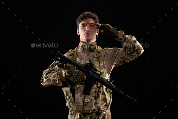 front view young soldier in uniform with rifle on black background tank ...