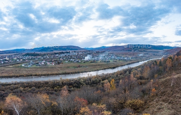 River running across countryside against distant mountains Stock Photo ...