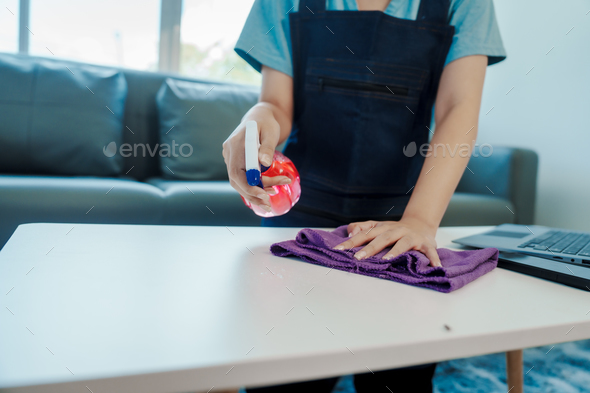 Cleans floor and desk. Hand of asian chinese woman wiping work desk ...