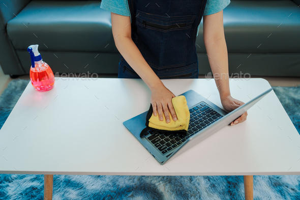 Cleans floor and desk. Hand of asian chinese woman wiping work desk ...