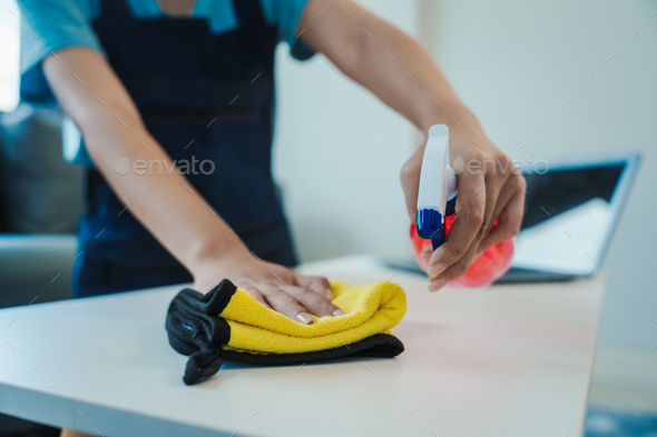 Cleans floor and desk. Hand of asian chinese woman wiping work desk ...