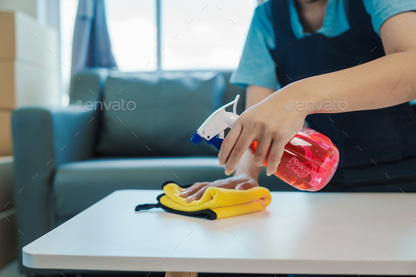 Cleans floor and desk. Hand of asian chinese woman wiping work desk ...