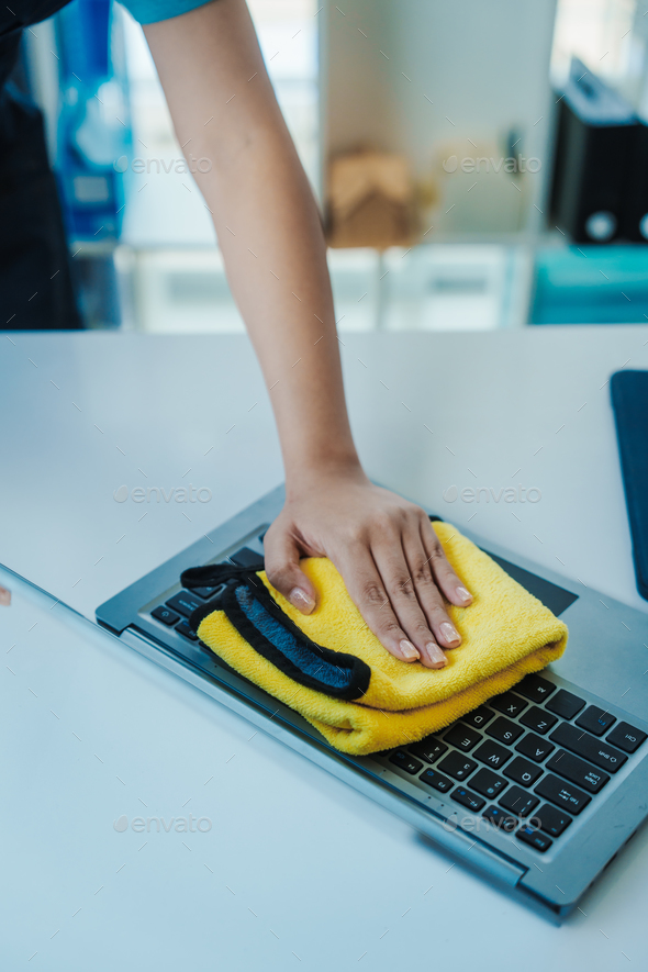 Cleans floor and desk. Hand of asian chinese woman wiping work desk ...