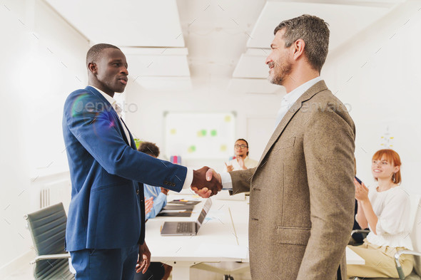Multicultural Office Handshake Stock Photo by baffos | PhotoDune