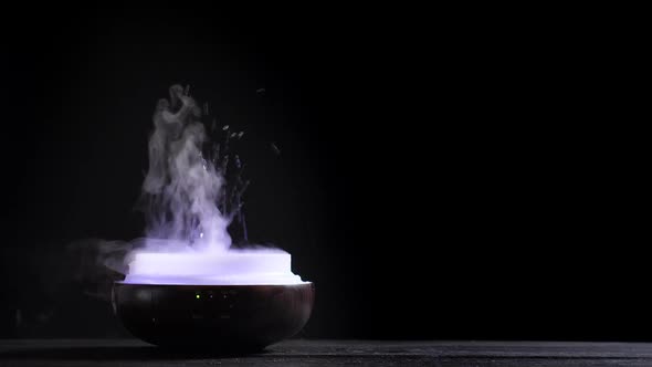 Open Diffuser for Essential Oils Diffusing Steam on Black Background ...