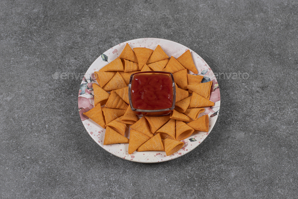 Triangle shaped crackers on plate with ketchup Stock Photo by 13people
