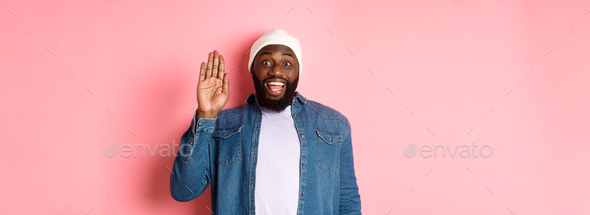 Friendly smiling Black man saying hello, waving hand, greeting you ...