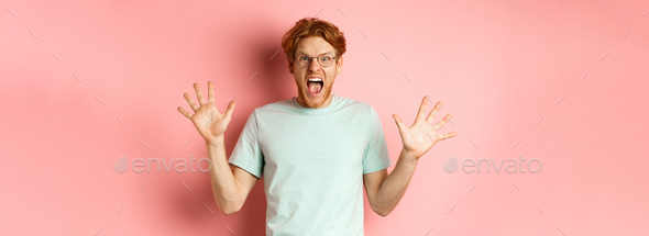 Angry and pressured young man losing temper, spread hands sideways and ...