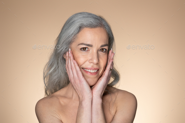 Portrait Of Sensual Senior Grey Haired Woman Touching Her Face And