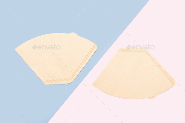 Paper coffee filters on blue and pink background top view close-up ...