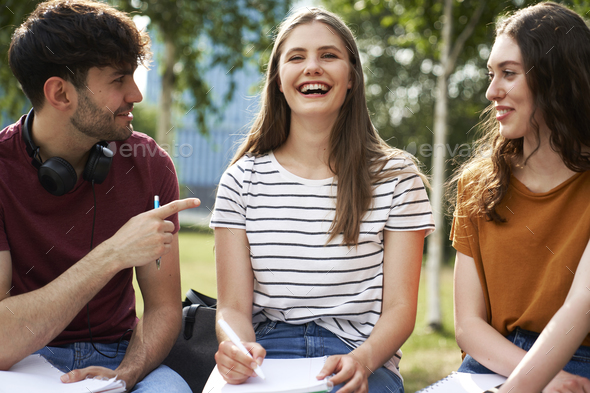 Group of three caucasian students having fun outside the university ...
