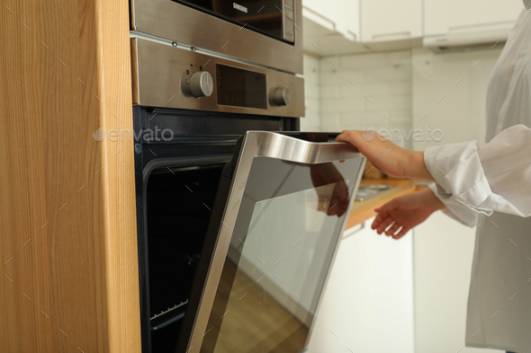 Oven for baking, hand open door, side view, close-up Stock Photo by ...