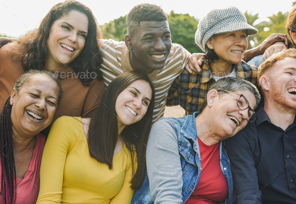 Happy multi generational people having fun hugging each other at city ...