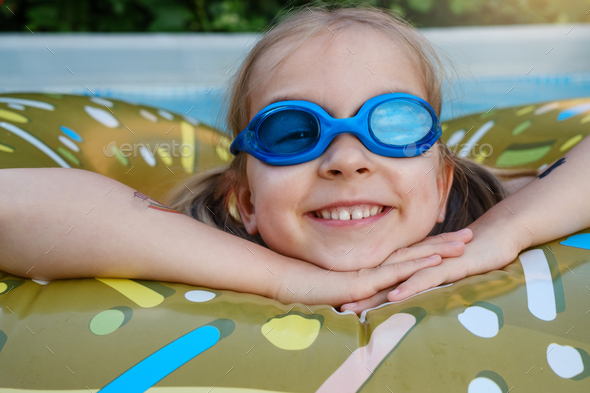 Happy preschool girl in outdoor swimming pool in backyard Stock Photo ...