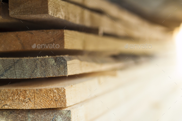 Stack of new wooden studs at the lumber yard. Wood timber construction ...