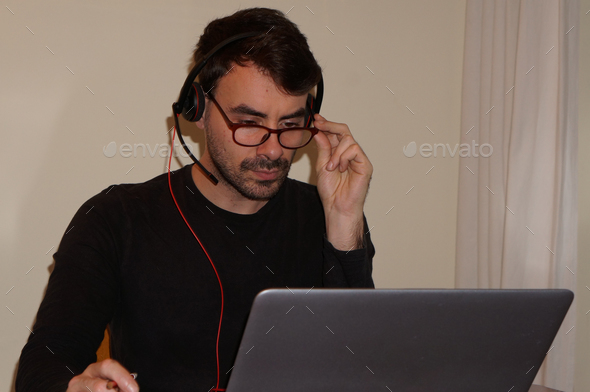 Handsome young man at work, making a phone call with a headset Stock ...