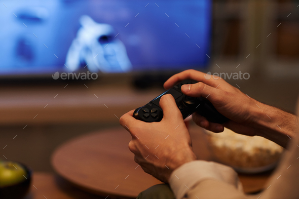Unrecognizable ,an holding controller playing videogames at home Stock ...