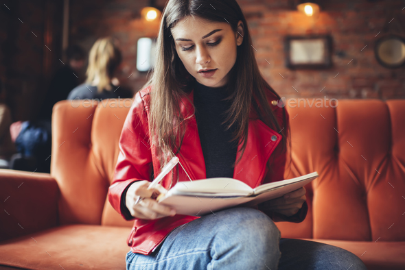 Serious woman reading notes in copybook Stock Photo by GaudiLab | PhotoDune