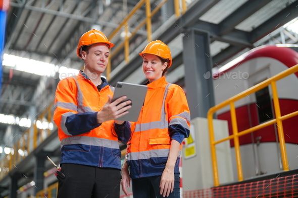 Two Technicians or Engineers Checking and maintaining Machine Equipment ...