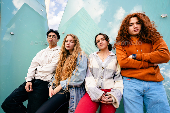 Portrait group of young Gen Z friends standing with serious expression ...