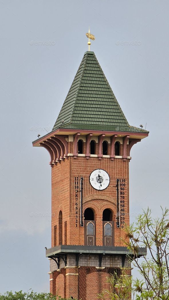 Vertical of a tall clock tower building against a cloudy sky Stock ...