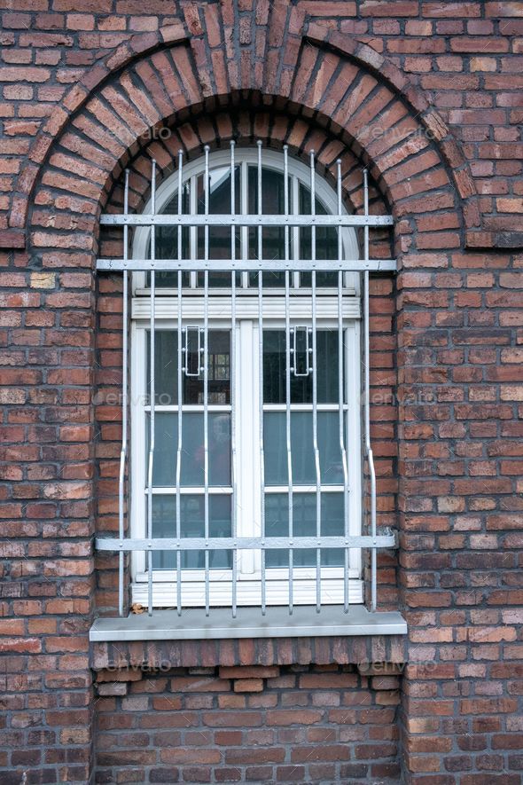 Traditional brick building with an old-fashioned barred window Stock ...