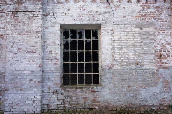 Traditional brick building with an old-fashioned barred window Stock ...