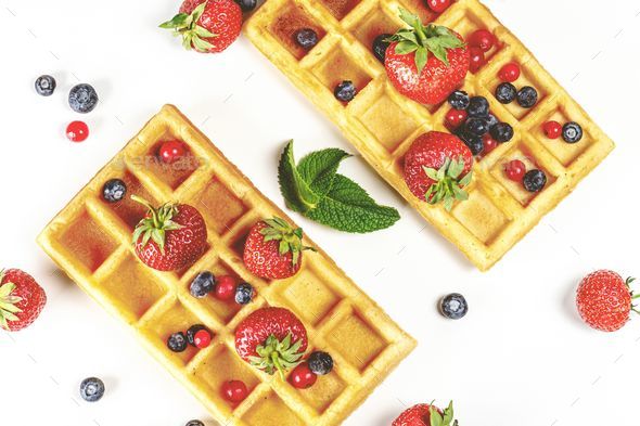 two waffles sitting next to each other on top of a white table Stock ...