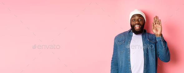 Friendly smiling Black man saying hello, waving hand, greeting you ...