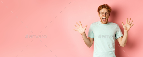 Angry and pressured young man losing temper, spread hands sideways and ...