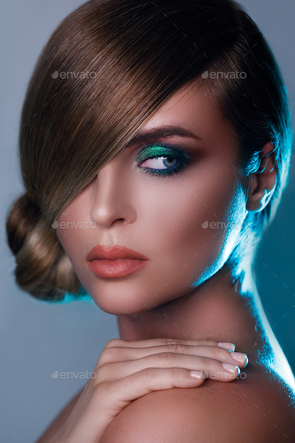 Model in stylish image with sleek hair covering one eye and beautiful ...