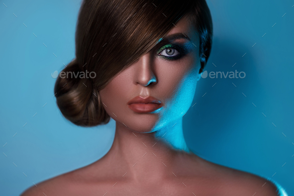 Model in stylish image with sleek hair covering one eye and beautiful ...