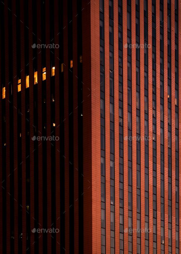 an outside photo of a building at night time with one large light ...