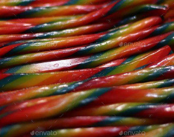 Closeup of an array of rainbow-colored candies Stock Photo by wirestock