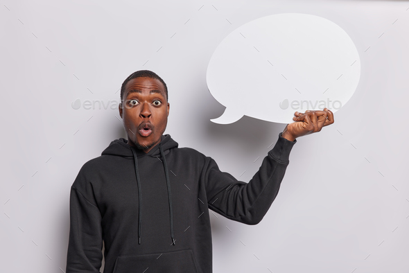 Photo of shocked dark skinned man holds blank speech bubble has ...
