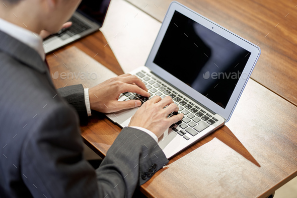 At hand of an Asian business person working on a personal computer ...