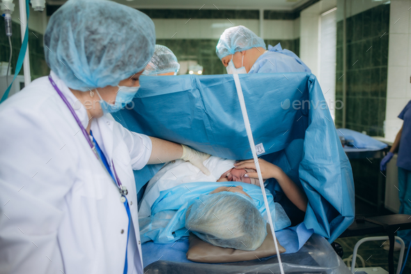 First sight of mom and her newborn in operation room Stock Photo by ...