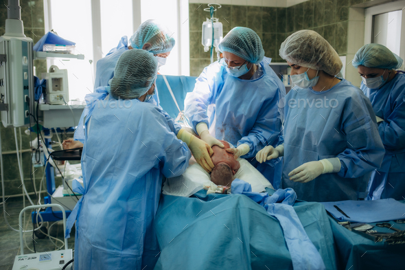 Doctor surgery team in the operating room of abdominal cesarean section ...