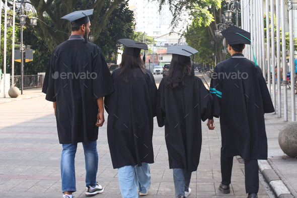 Backside view of group of graduate students walking together Stock ...