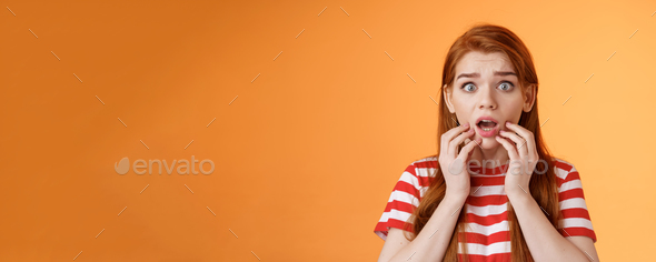 Scared shocked redhead woman worry, stare camera speechless gasping ...